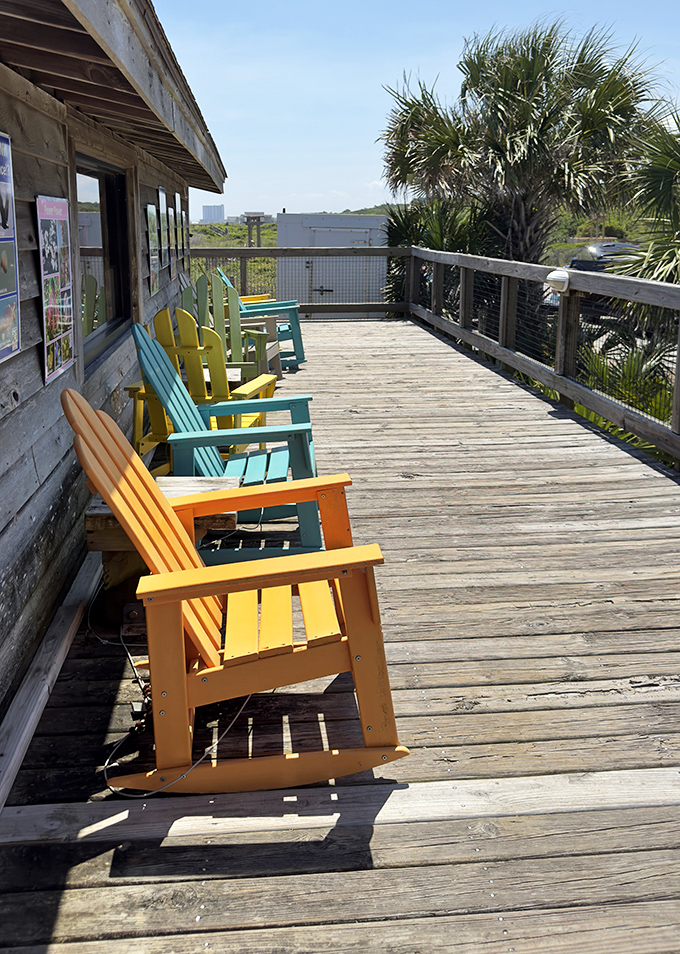 Adirondack chairs in cheerful colors invite contemplation. The unofficial meeting spot for sunset appreciation societies.