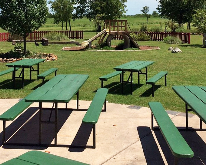 Where kids play while adults contemplate a second helping of catfish. This outdoor space turns a meal into an afternoon escape from reality.