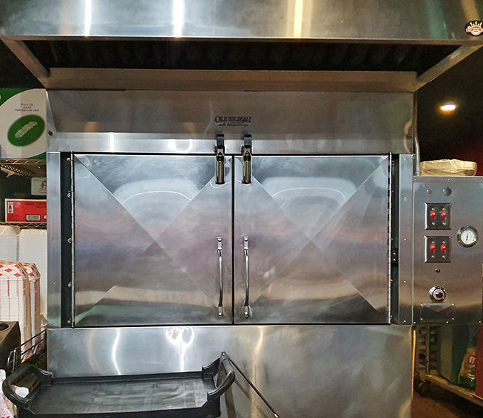 Behind these stainless steel doors, magic happens slowly. The smoker &ndash; where patience transforms tough cuts into tender treasures worth waiting for.