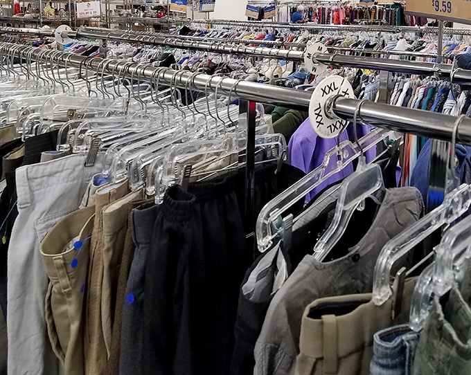 Pants, organized with military precision. The XXL tag stands guard like a retail sergeant overseeing rows of khaki and denim recruits.