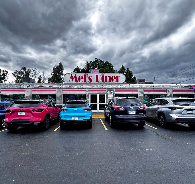 Even on cloudy days, Mel's Diner's sign shines like a beacon, with a parking lot that fills up faster than you can say "blue plate special."