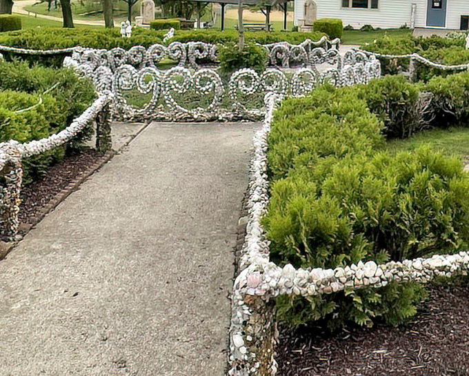 Elegant white stone railings curve alongside manicured hedges&mdash;formal garden design with a distinctly Midwestern sparkle.