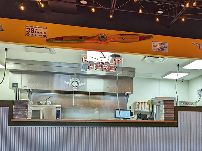 The pickup counter where dreams come true. That vintage airplane propeller overhead suggests your taste buds are about to take flight.