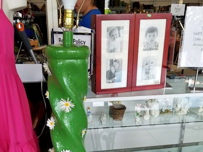 Someone's memories find new life through a vibrant green lamp and a cherished photo frame. Yesterday's keepsakes become tomorrow's conversation pieces.