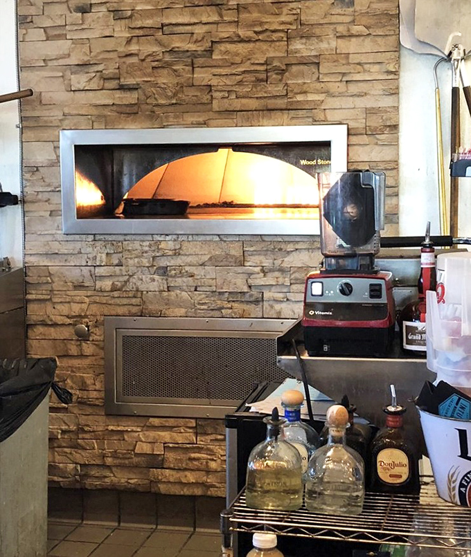 The brick oven where pizza dreams come true &ndash; proof that seafood restaurants can excel at unexpected culinary plot twists.