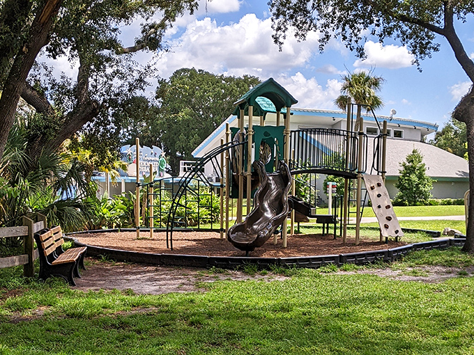 A playground where kids can burn off energy while parents secretly calculate how long until they can hit the spring-fed swimming area.