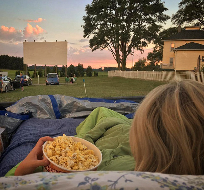 The quintessential drive-in experience: fresh popcorn in hand, cozy blankets, and a sunset view that rivals whatever's playing on screen.