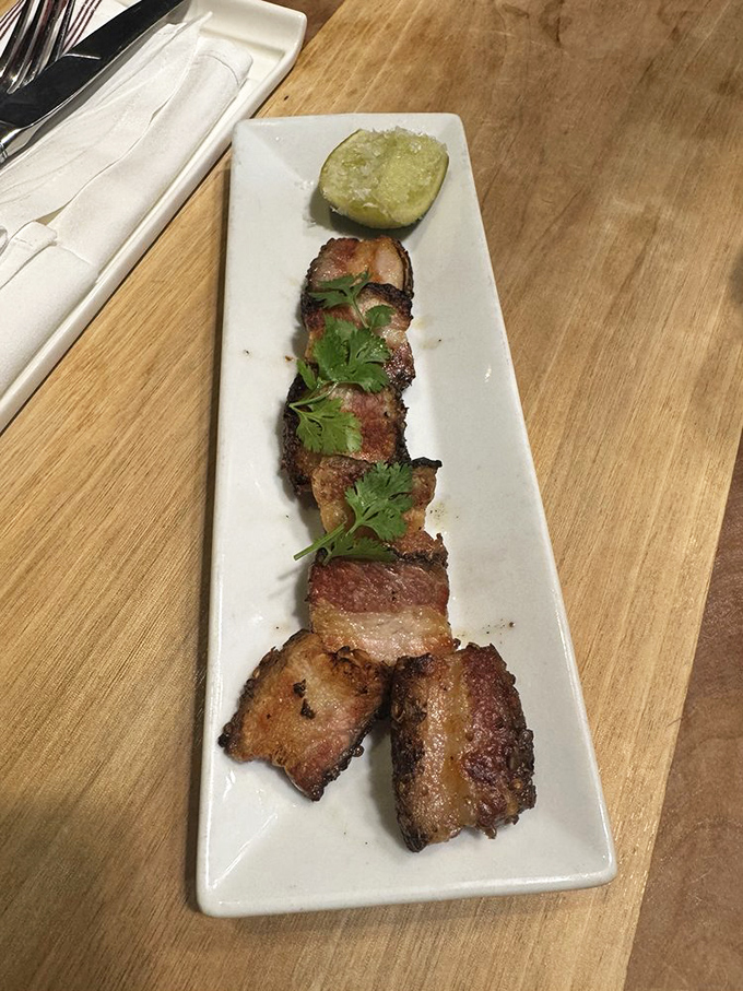 Pork belly so perfectly rendered and caramelized it should come with its own warning label: "May cause involuntary food moans."