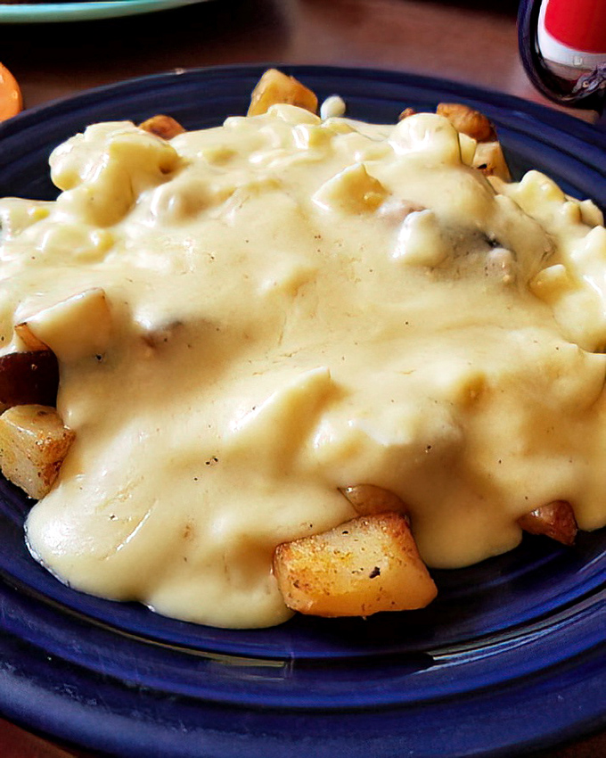 Home fries swimming in cheese sauce&mdash;a glorious indulgence that makes vegetables merely an afterthought.