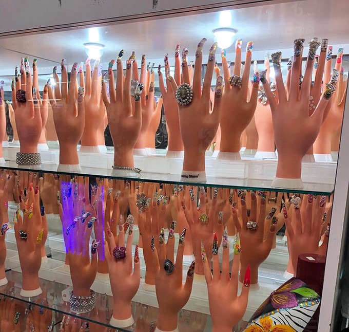 A forest of mannequin hands reaches skyward, each one modeling nail art that ranges from subtle to spectacularly bold.
