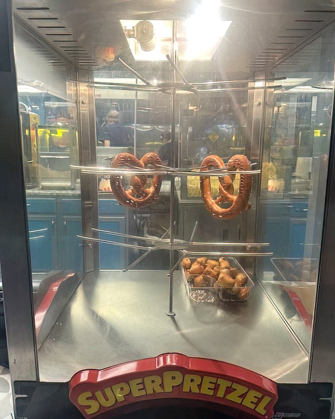 Those Super Pretzels twist behind glass like edible sculptures, waiting to be dunked in mustard.