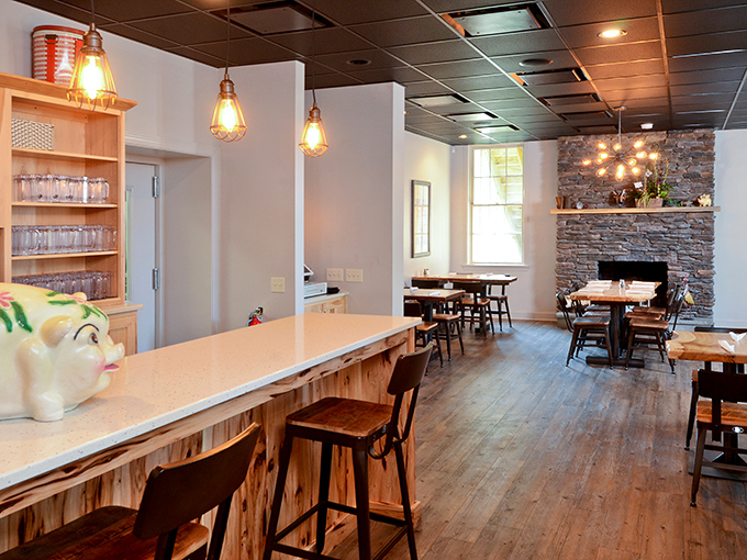 Stone walls meet wood paneling in a space that feels both modern and timeless. Those Edison bulbs cast the perfect glow for serious eating.