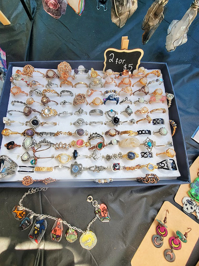 Rings spread across velvet like tiny promises, where five dollars buys you instant glamour or future garage sale inventory.