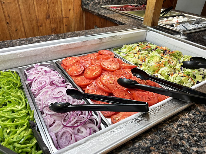 The salad bar's vibrant lineup of fresh vegetables stands as a colorful monument to good intentions before the inevitable dessert table visit.
