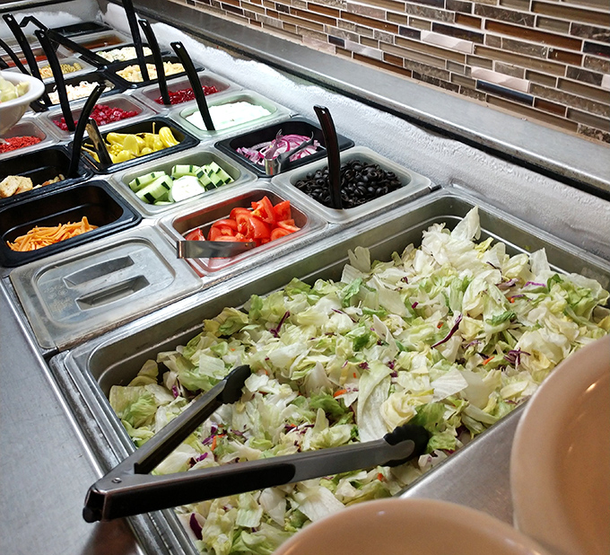 The salad bar stands ready like a colorful army of vegetables, proving that "all-you-can-eat" doesn't have to be a threat to your arteries.