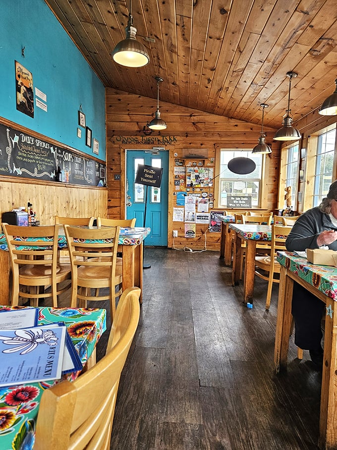 Simple wooden tables, bright blue walls, and pendant lighting create that perfect "I've discovered something special" atmosphere that makes meals memorable.