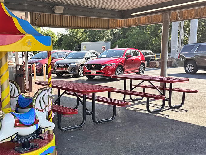 Outdoor dining with a side of childhood joy&mdash;vintage kiddie rides and picnic tables create the perfect setting for making multi-generational memories.