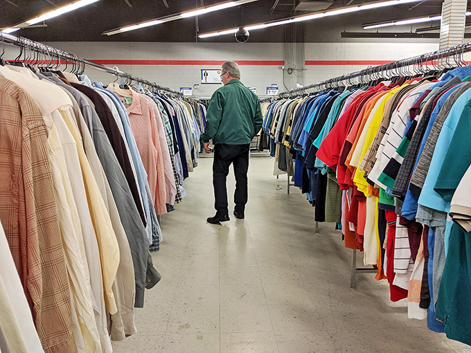 Shoppers navigate clothing aisles with the focused determination of serious treasure hunters on a mission.