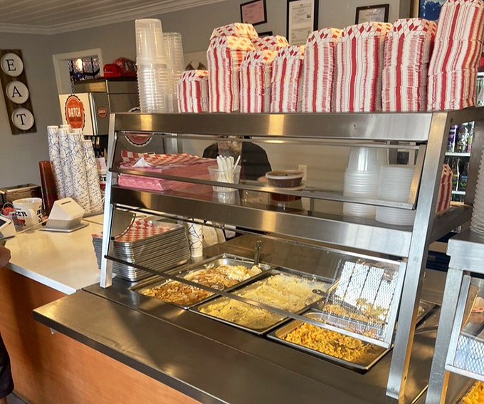 The serving line&mdash;where dreams come true and diets go to die. Each metal tray holds the promise of smoky perfection.