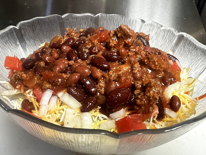 The taco salad that makes eating vegetables feel like cheating. Seasoned beef, beans, and cheese transform ordinary lettuce into a fiesta that your diet plan never saw coming.