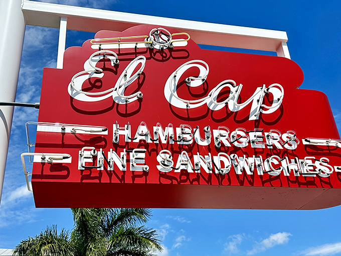 El Cap's vintage neon sign glows like a lighthouse for the hungry. Some beacons guide ships; this one guides appetites.