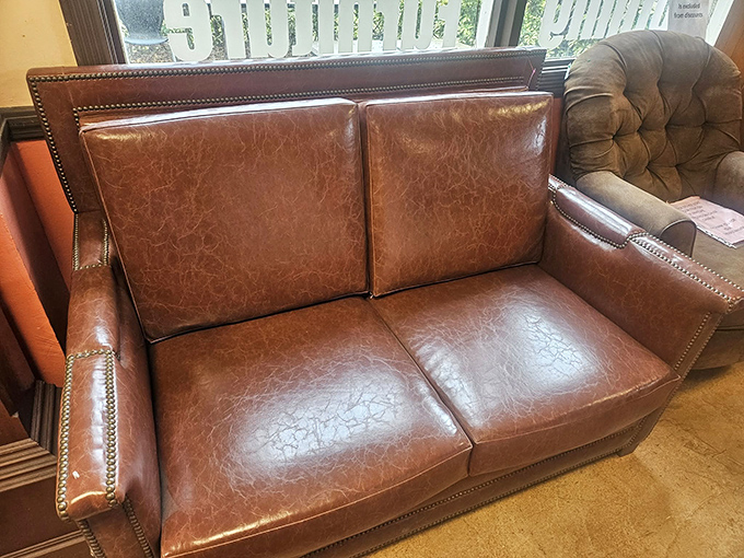 The leather loveseat that's seen some stories but kept its dignity. Perfect for the home office or that corner that's begging for a touch of vintage class.