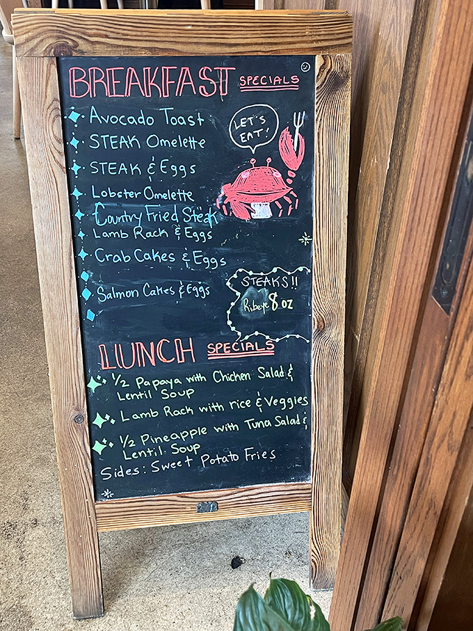 A specials board that reads like a bucket list for breakfast enthusiasts. That little crab illustration is practically winking at you.