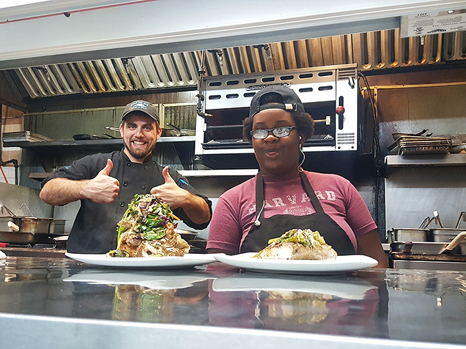 The kitchen crew giving thumbs up because they know what's about to hit your table will change your seafood standards forever.