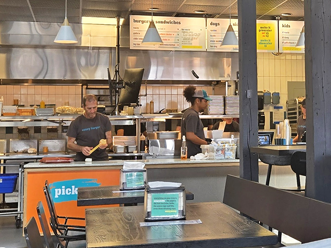 Where burger magic happens. The open kitchen concept lets you witness the choreography that transforms simple ingredients into extraordinary meals.