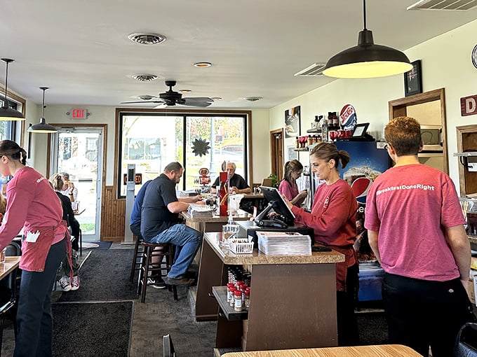 The choreography of a busy diner kitchen &ndash; where staff in matching shirts move with the practiced precision of a small-town ballet. 