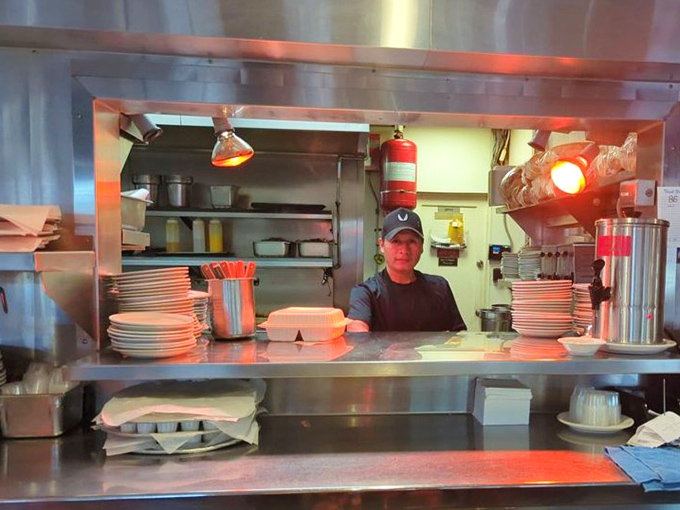 The kitchen crew throwing peace signs like they just won the breakfast Olympics &ndash; and honestly, they might have.