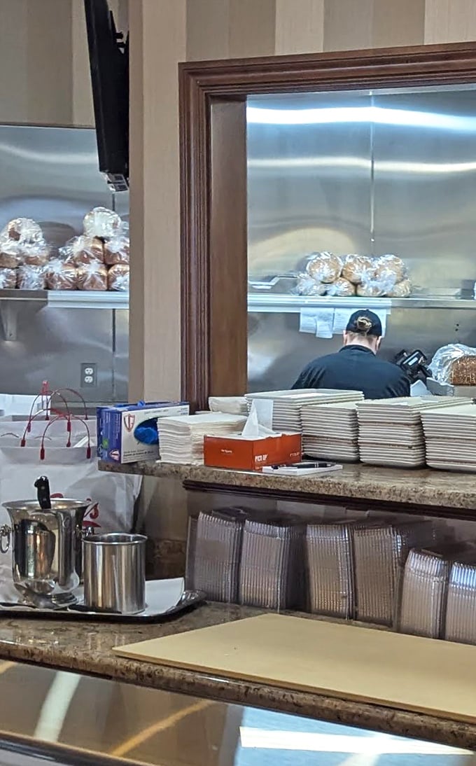 Behind the scenes, skilled hands prepare the next round of wrapped delights, each package a testament to the art of the sandwich. 