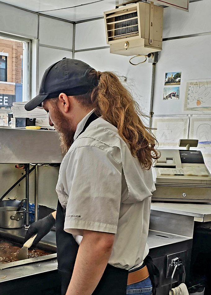 Where burger magic happens. Those hands have likely flipped more patties than most of us have flipped calendar pages.