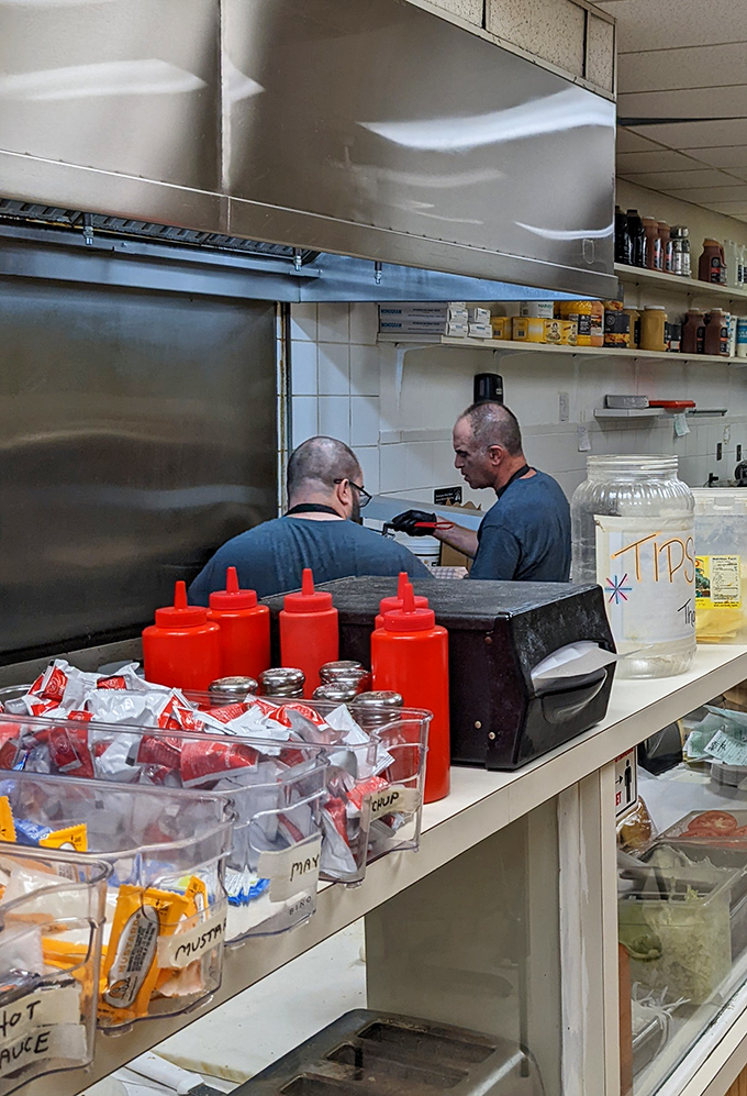 Behind the scenes where sandwich magic happens. Those squeeze bottles aren't just condiment containers&mdash;they're flavor wands in the right hands.