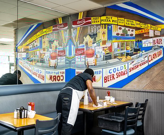 The colorful mural transports you to a bygone era of boardwalk delights, while staff members orchestrate the perfect deli experience.
