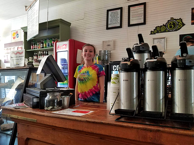 Behind the counter, where sandwich dreams become reality. Coffee urns stand at attention, ready to provide liquid fortification for your culinary journey.