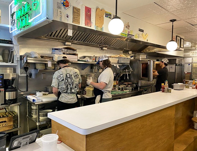 The kitchen crew in action&mdash;sandwich architects working their magic behind the counter with the focus of brain surgeons and the flair of jazz musicians.