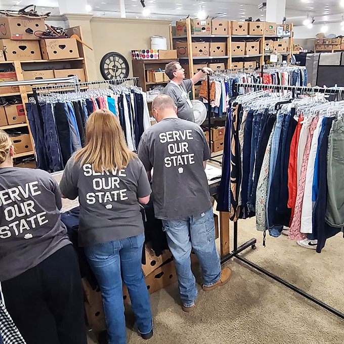 Volunteers in "Serve Our State" shirts work the clothing racks with the dedication of fashion buyers at a high-end department store.