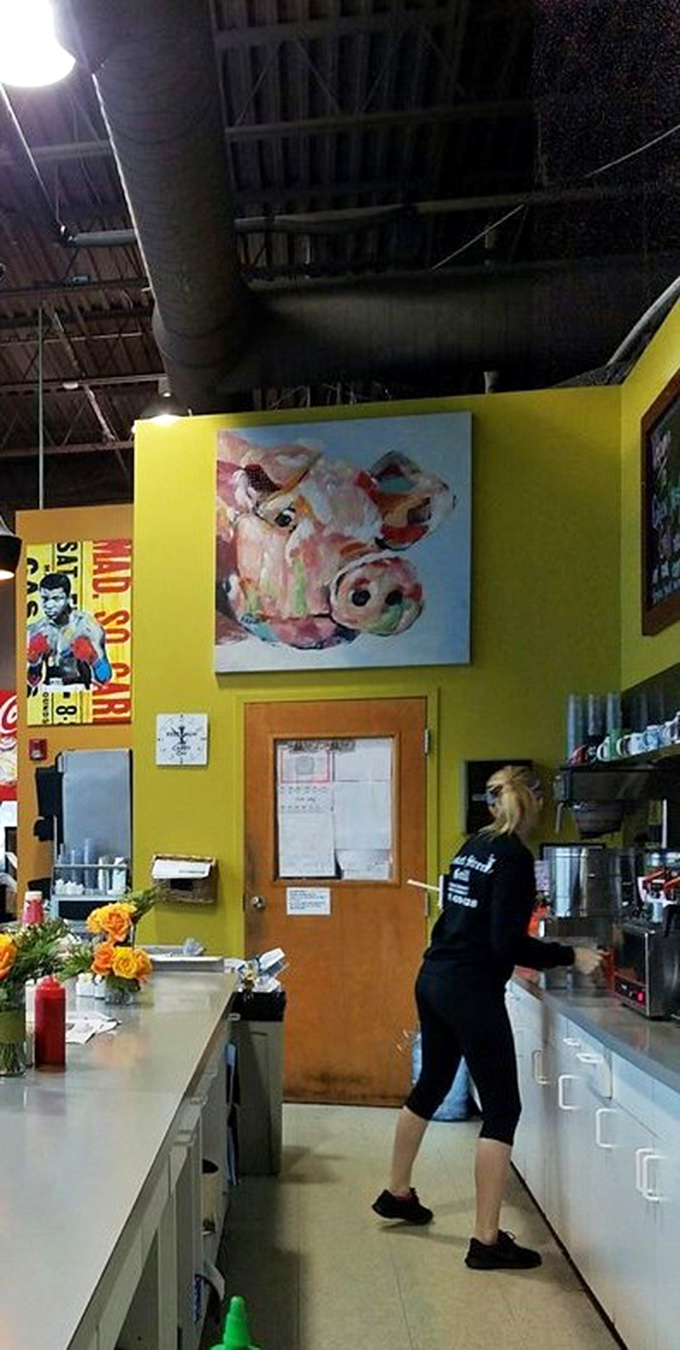 Bright yellow walls and whimsical artwork create a cheerful backdrop in the kitchen area where breakfast magic happens.