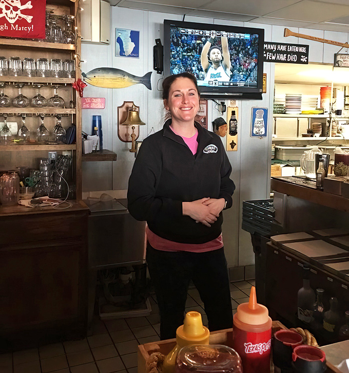 Behind every great seafood joint is a staff that knows their stuff. The nautical-themed bar behind her holds liquid treasures worth exploring.