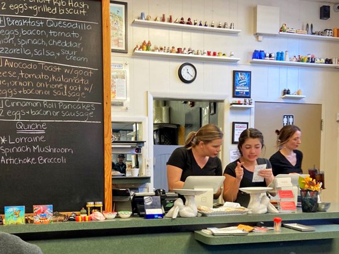 Behind every great breakfast is a team of dedicated staff, working their morning magic while surrounded by chalkboard specials and tiny collectibles.