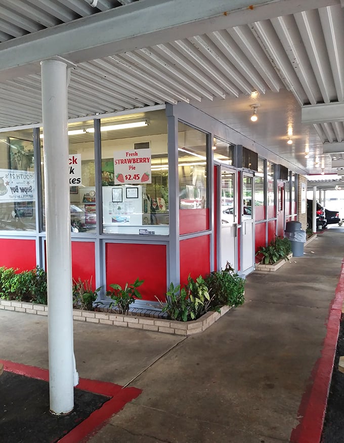 The walkway's red trim and white columns create a retro runway leading hungry patrons to burger bliss, unchanged while Charlotte has transformed around it.