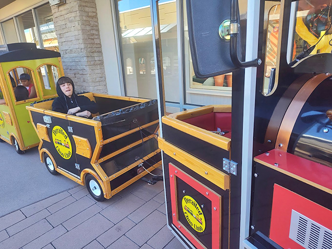 All aboard the bargain express! This miniature train delights young shoppers while parents secretly calculate how many shopping bags can fit in each car.