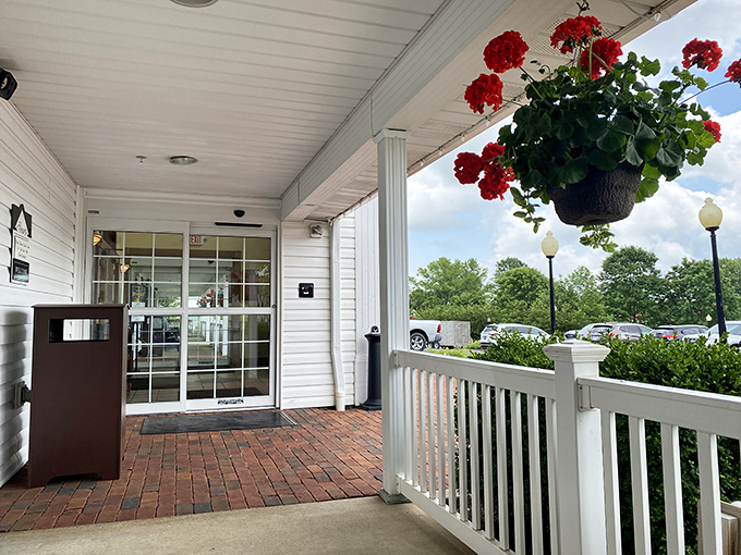The front porch welcomes visitors with rocking chairs and hanging flowers, setting the tone before you've even picked up a menu.