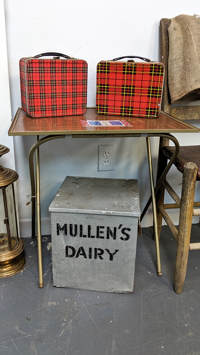 Vintage plaid lunch boxes that once carried PB&Js now carry nostalgia, perched above a dairy crate that's seen more American history than your high school textbook.