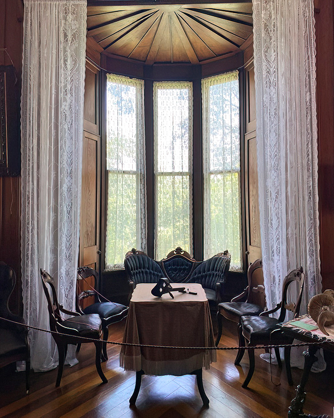 This elegant bay window sitting area proves that even before smartphones, people needed special places to avoid conversation while pretending to be socially engaged.
