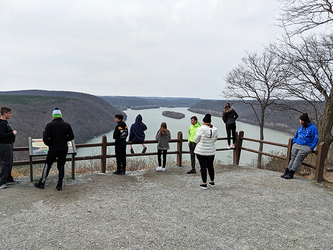 Visitors gather at nature's balcony, sharing collective amazement at views that unite strangers in appreciation of natural beauty.