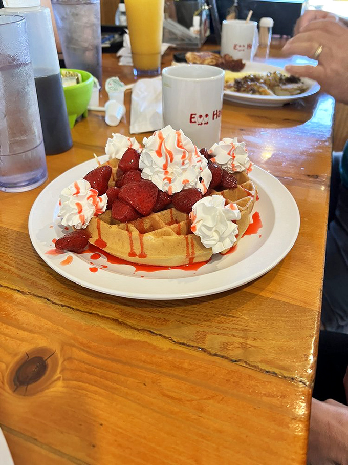 Waffle nirvana: crisp edges, tender center, crowned with strawberries and whipped cream &ndash; dessert masquerading as breakfast and fooling no one.