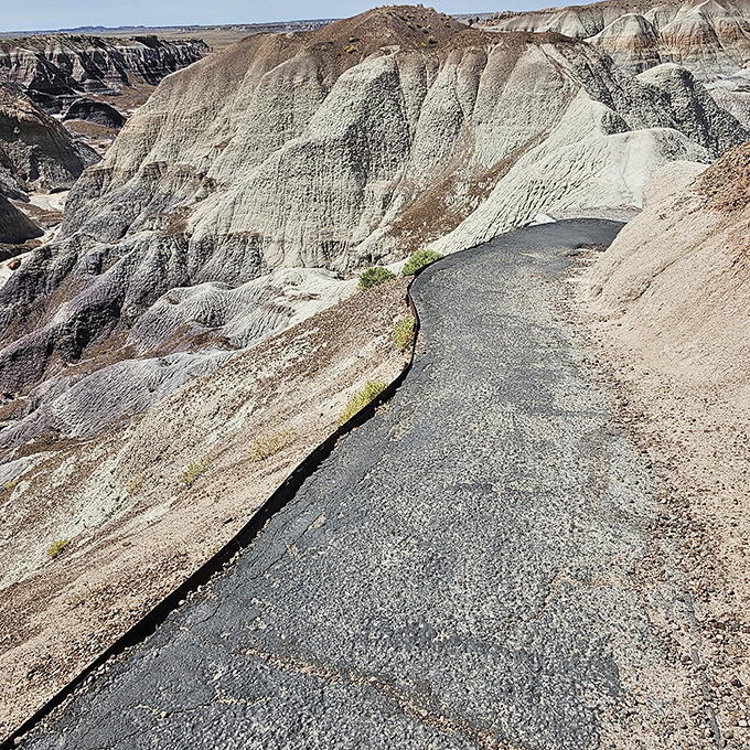 
The path less traveled, literally on the edge. This trail hugs the contours of the badlands, offering views worth every cautious step.