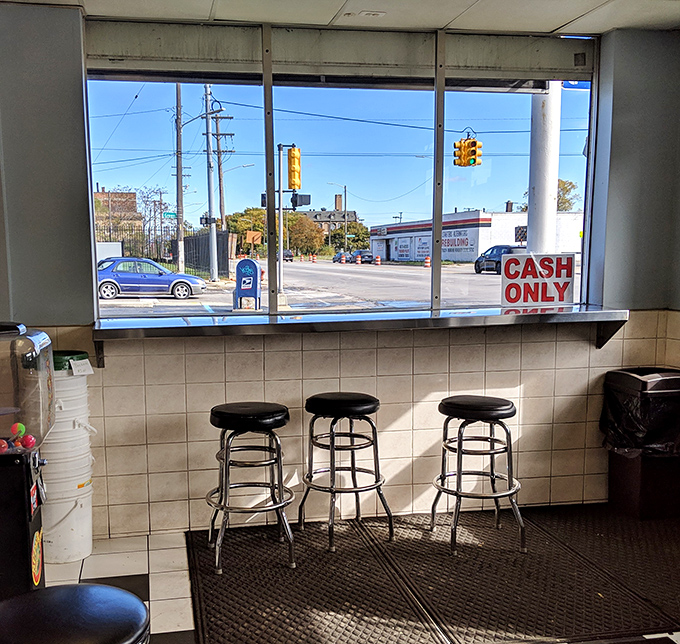 Window seats offer prime people-watching with your meal. The "CASH ONLY" sign is your first clue this place doesn't chase trends.